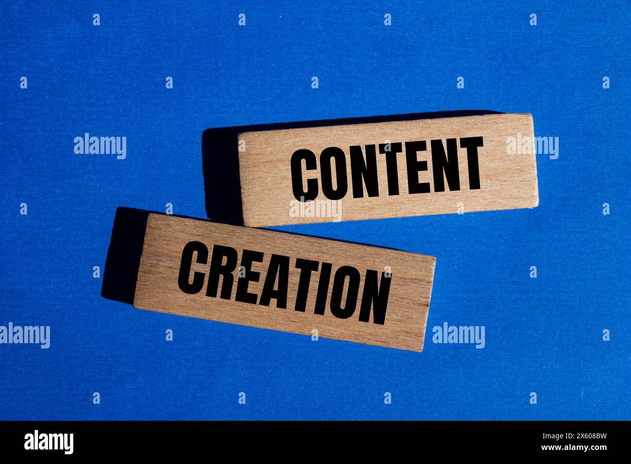 Content creation words written on wooden blocks with blue background ...