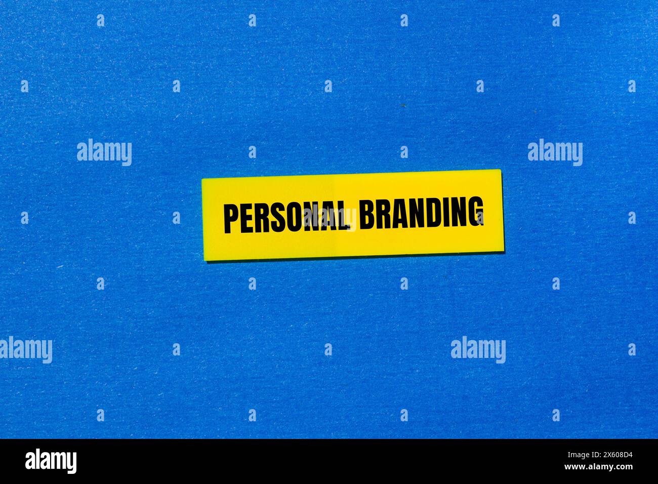 Personal branding words written on yellow paper sticker with blue ...