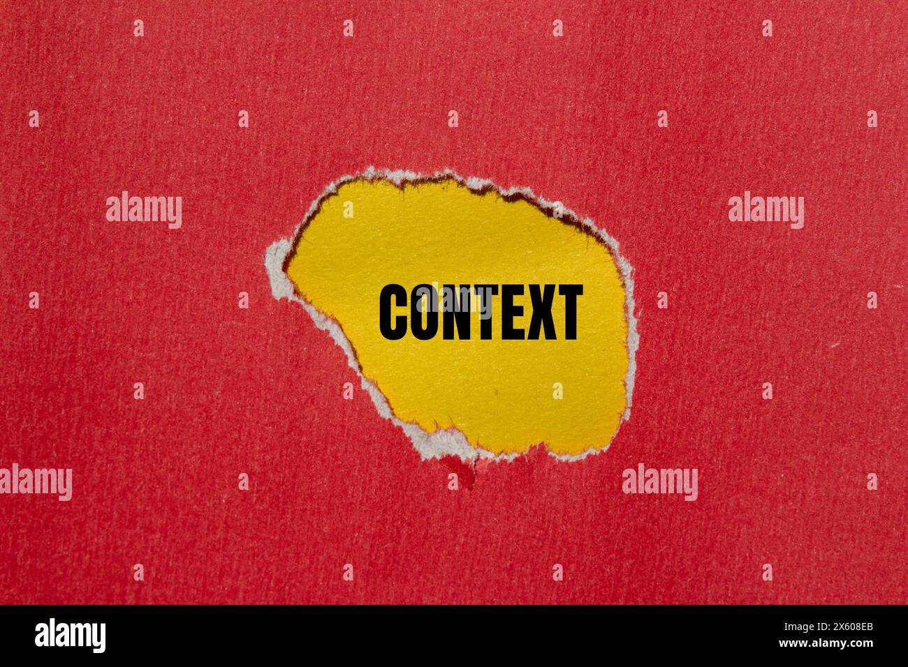Context word written on ripped red paper with yellow background ...
