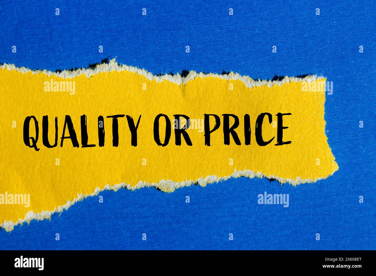 Quality or price words written on ripped yellow paper with blue ...