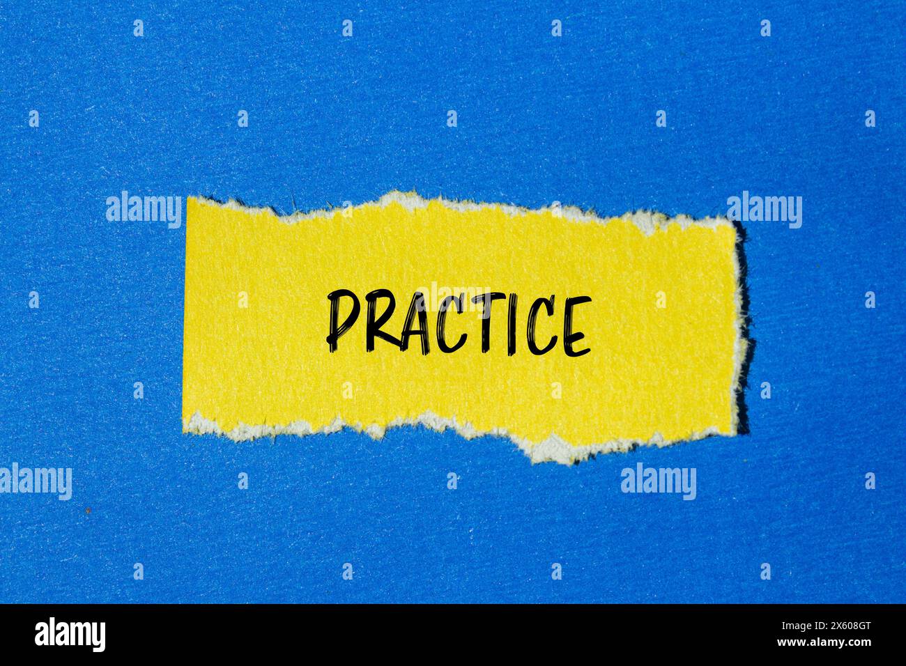Practice word written on ripped yellow paper with blue background ...