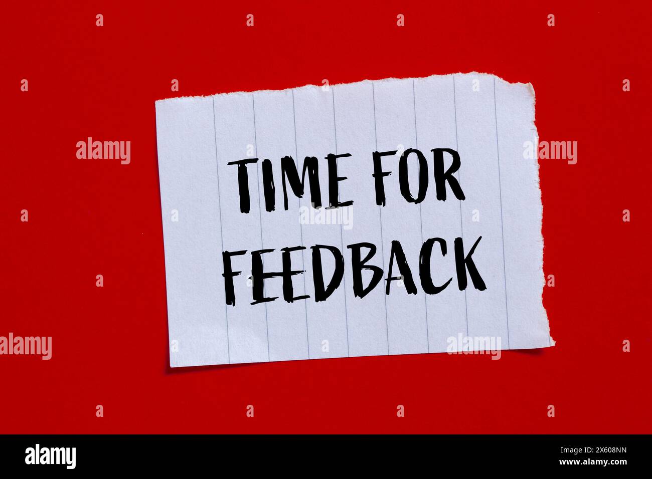 Time for feedback words written on ripped paper with red background ...