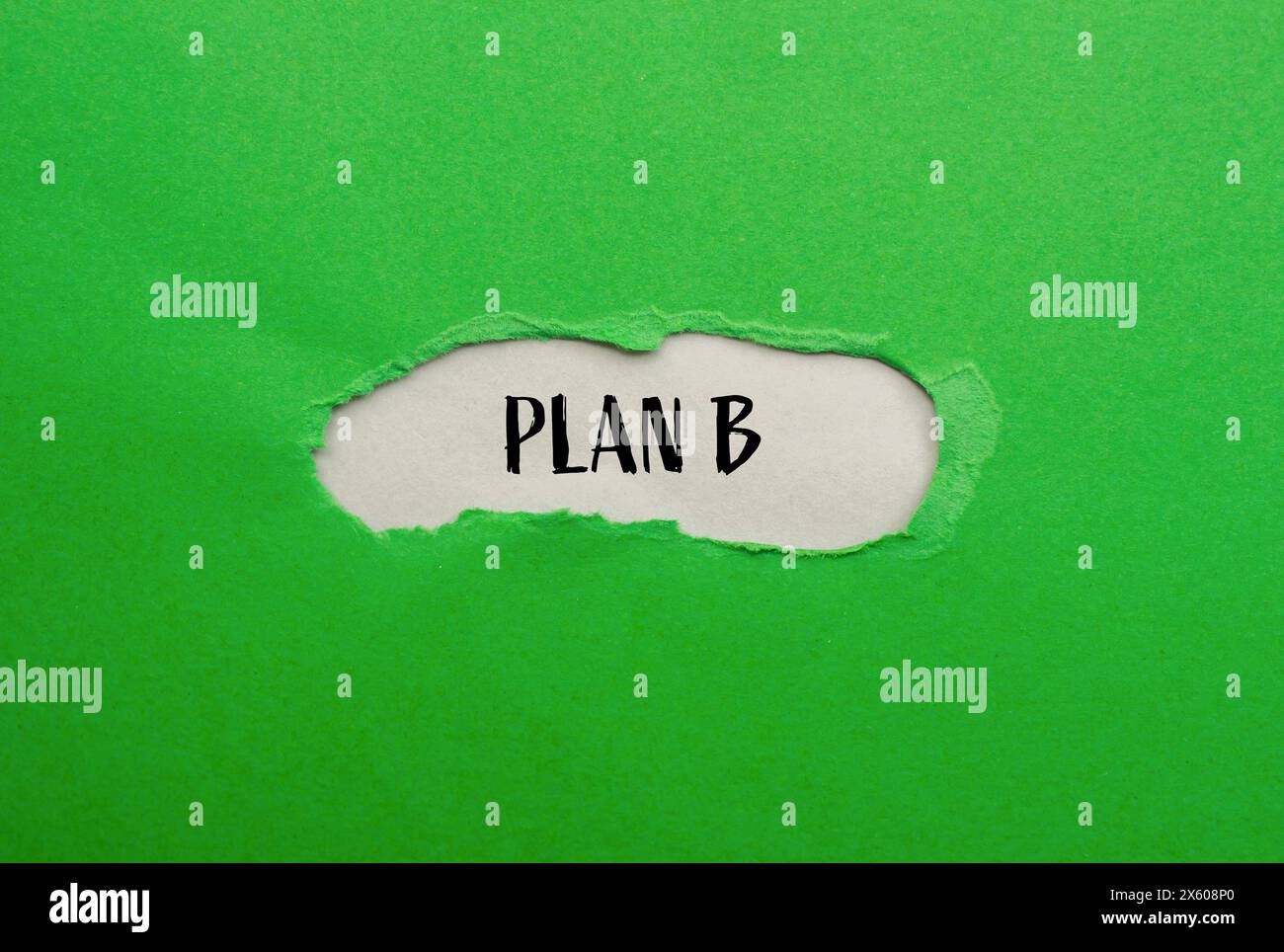 Plan b words written on ripped green paper with gray background ...