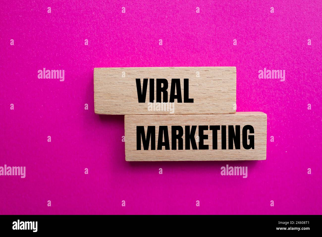 Viral marketing words written on wooden blocks with pink background ...