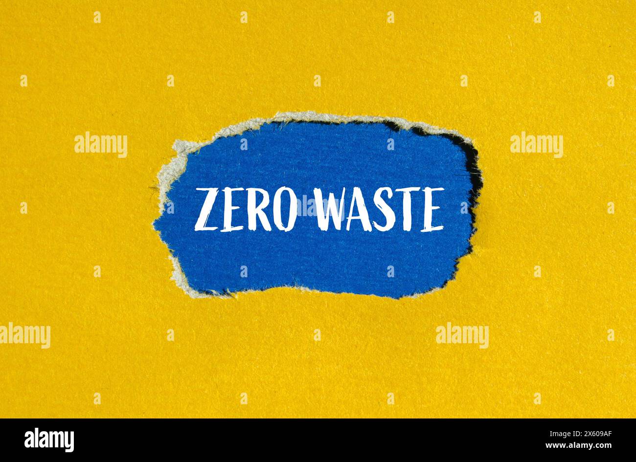 Zero waste words written on ripped yellow paper with blue background. Conceptual zero waste ...