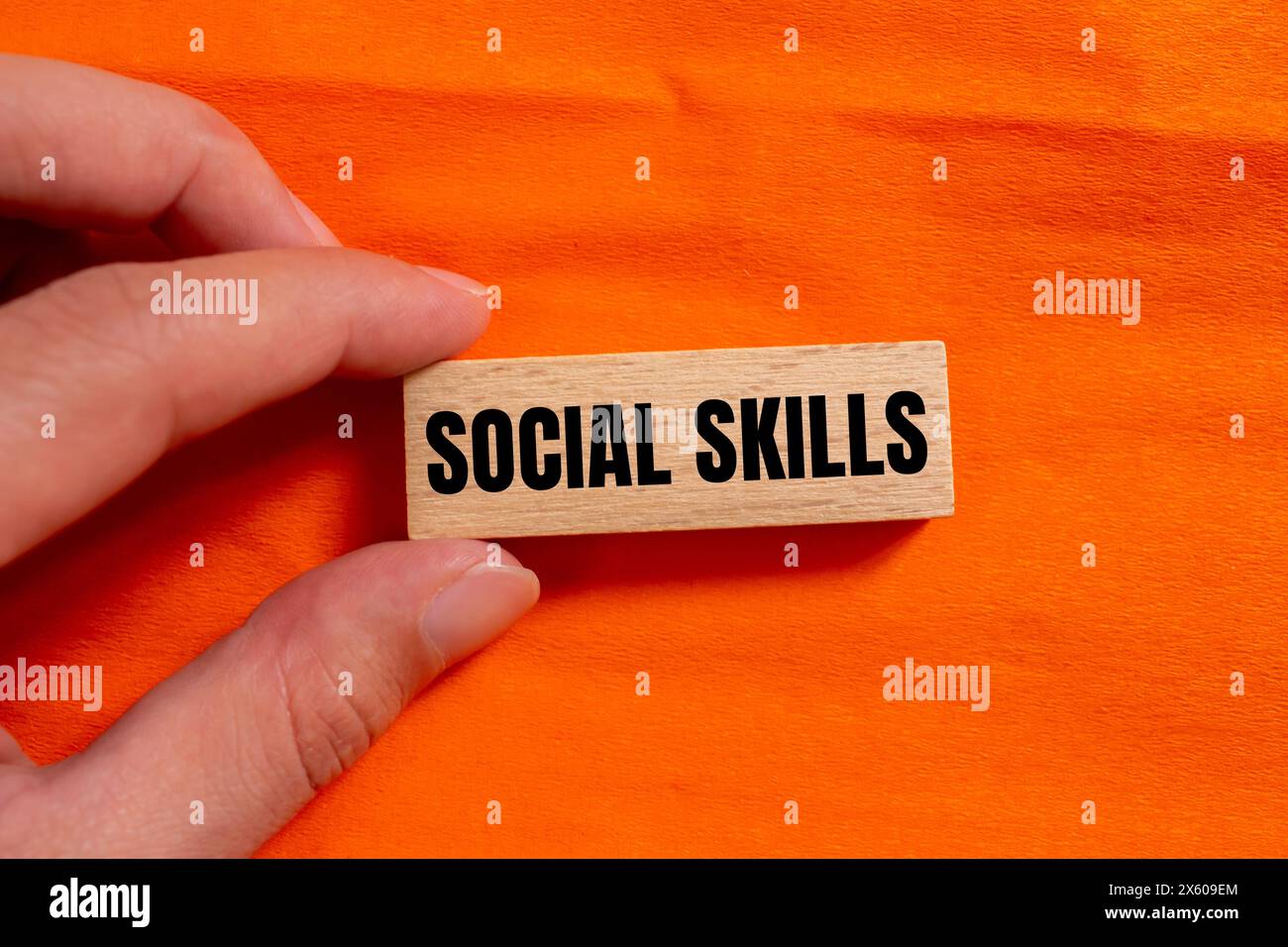 Social skills words written on wooden block with orange background ...