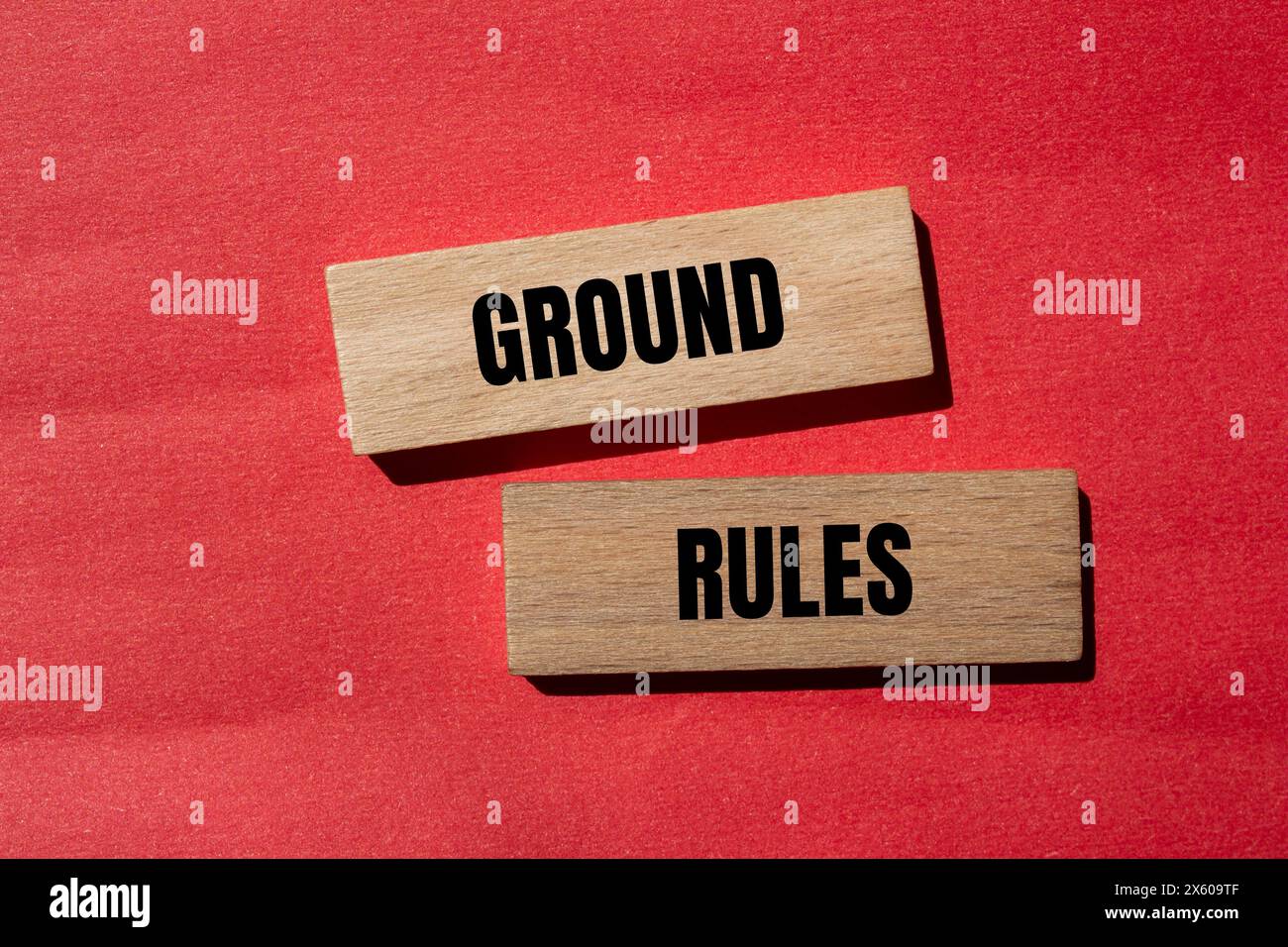 Ground rules words written on wooden blocks with red background ...