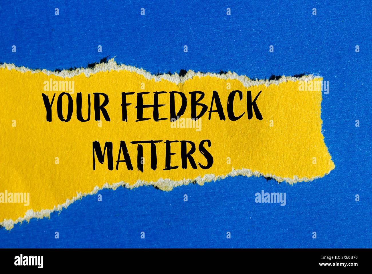 Your feedback matters written on ripped yellow paper with blue ...