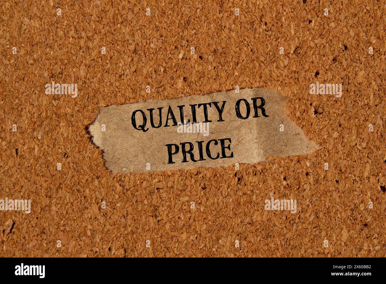 Quality or price words written on ripped paper piece with brown ...