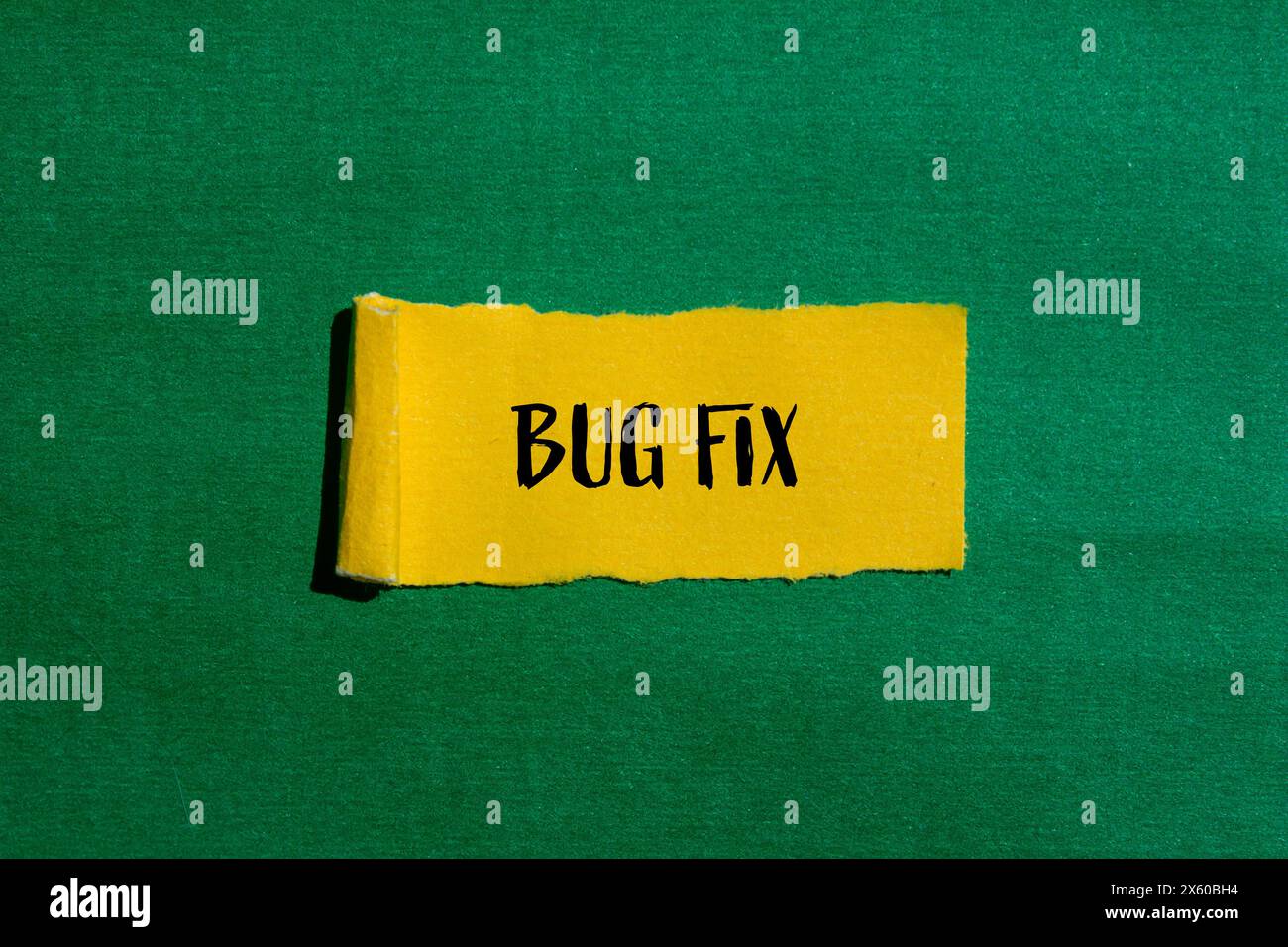 Bug fix words written on ripped yellow paper with green background ... Bug fix words written on ripped yellow paper with green background ...