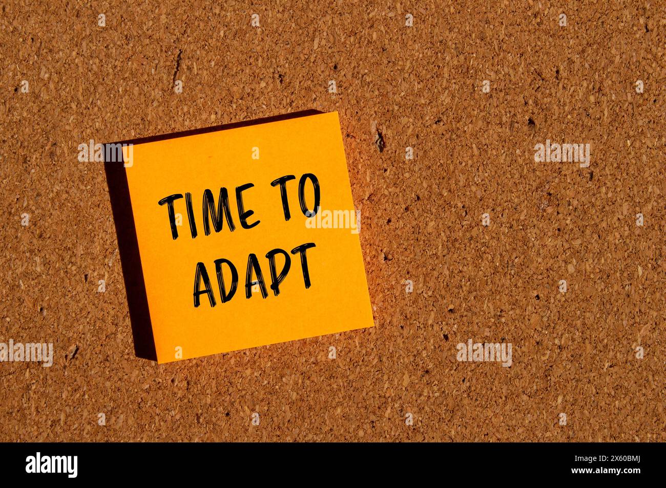 Time to adapt words written on orange paper sticker with brown ...