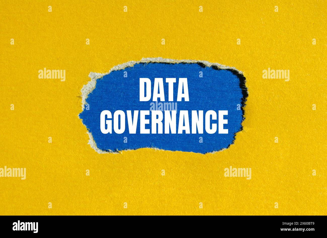Data governance words written on ripped yellow paper with blue ...