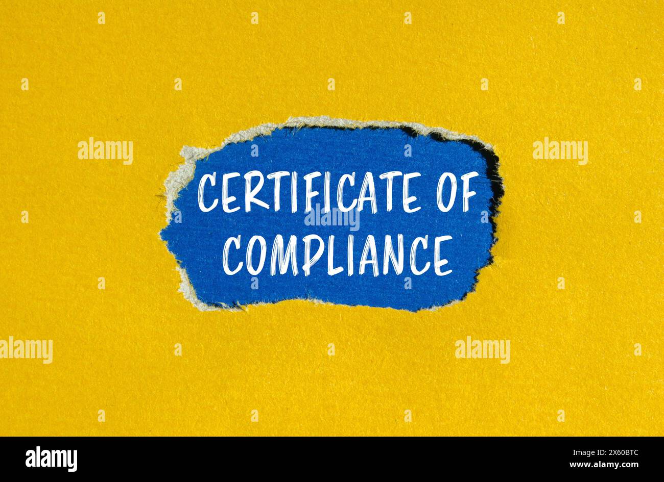 Certificate of compliance words written on ripped yellow paper with ...