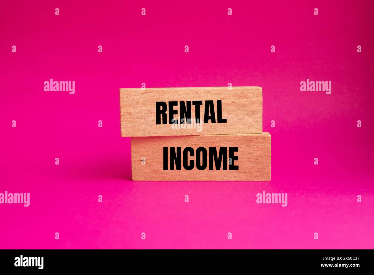 Rental income words written on wooden blocks with pink background ...