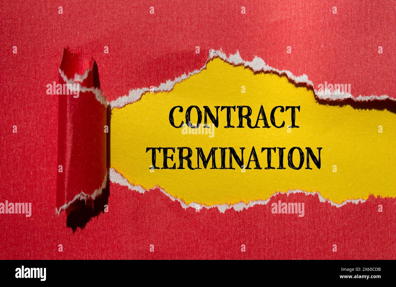 Contract termination words written on ripped red paper with yellow ...