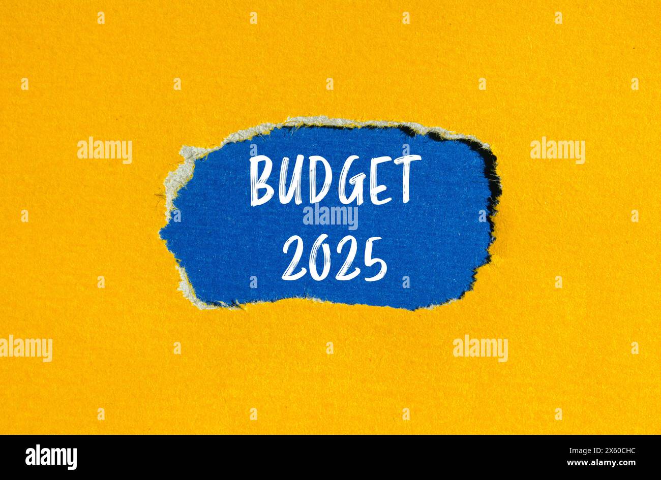 Budget 2025 words written on ripped yellow paper with blue background. Conceptual budget 2025 ...