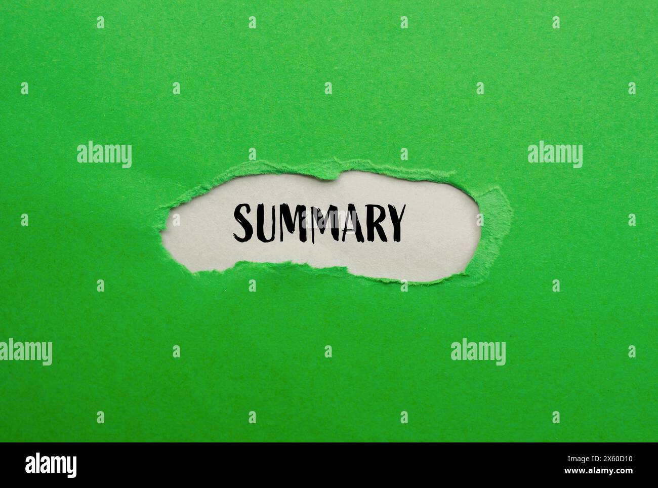 Summary word written on ripped green paper with gray background ...