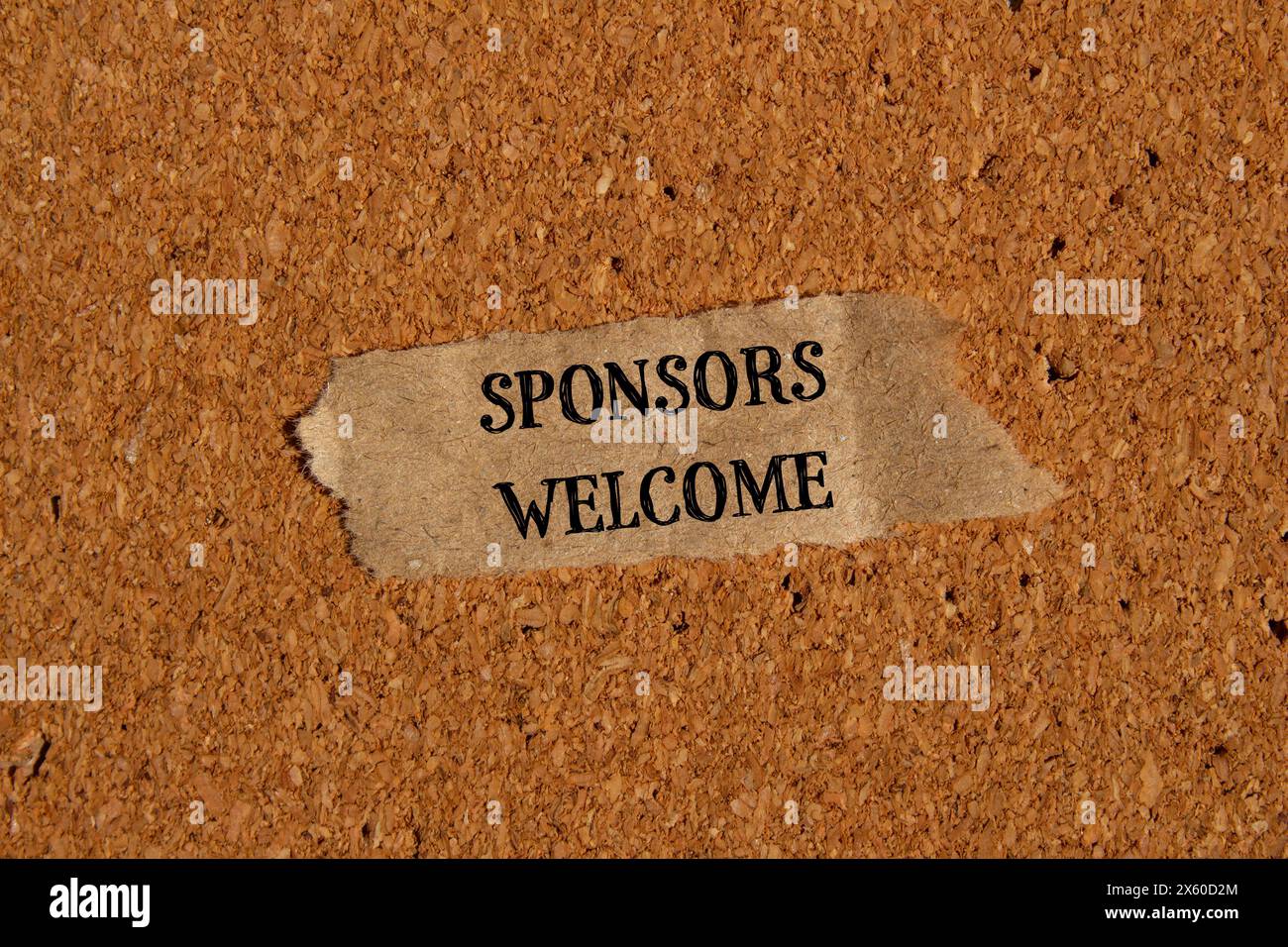Sponsors welcome words written on ripped paper piece with brown ...