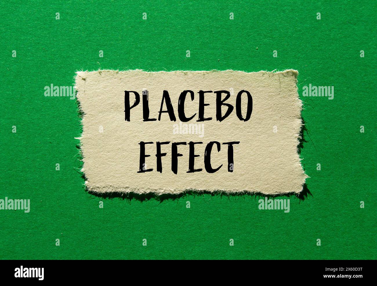 Placebo effect words written on ripped paper with green background ...