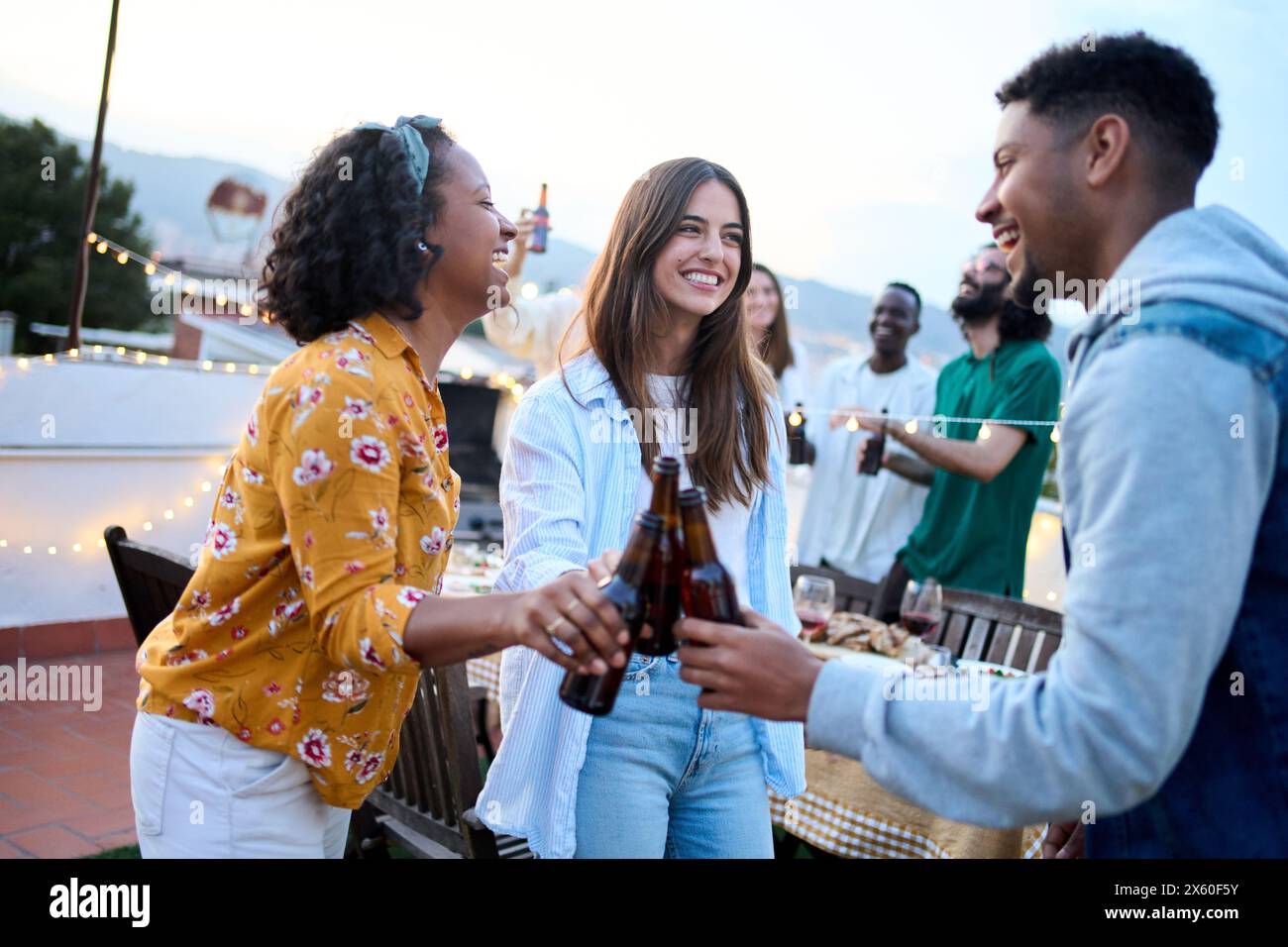 Young multiracial young people dancing together at rooftop party ...