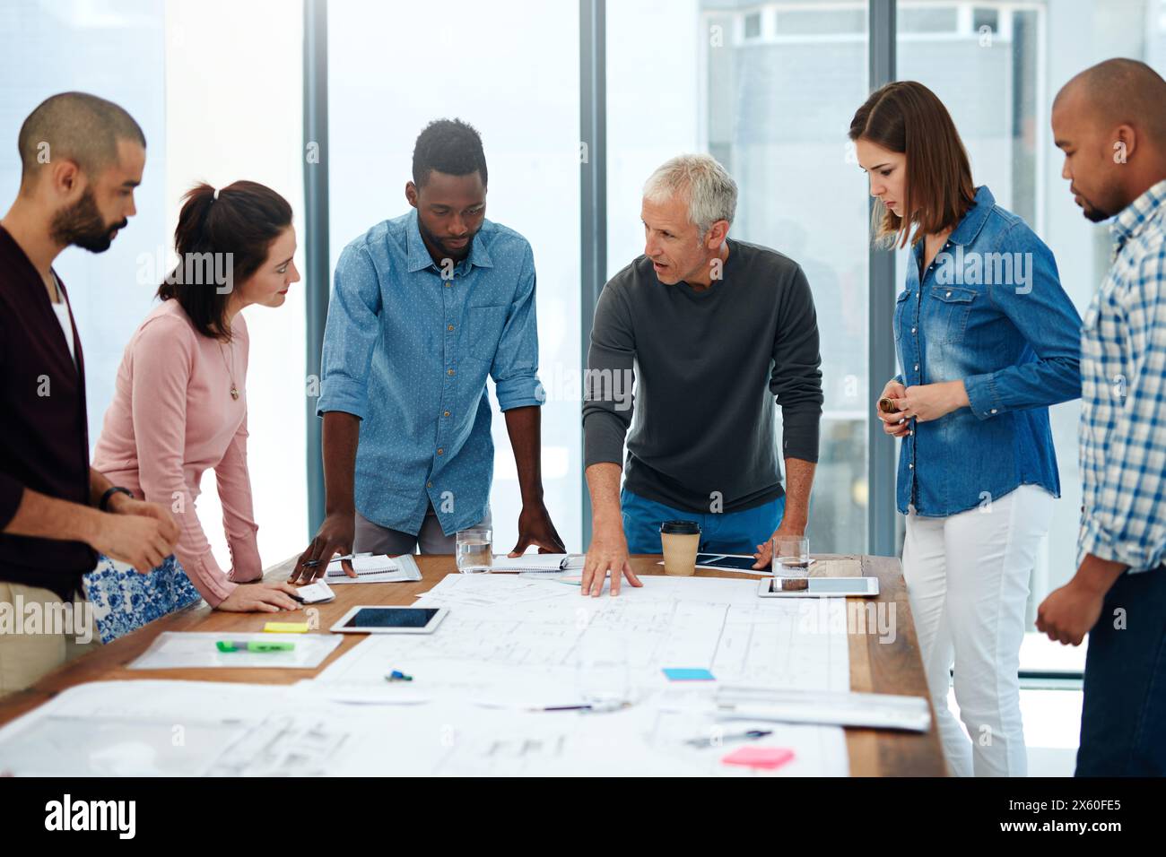 Business people, architect and discussion in meeting with floor plan ...