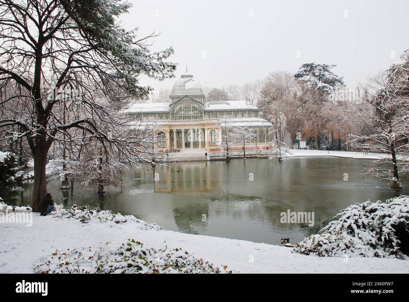 Snow covered Palacio de Cristal and pond. El Retiro park. Madrid. Spain ...
