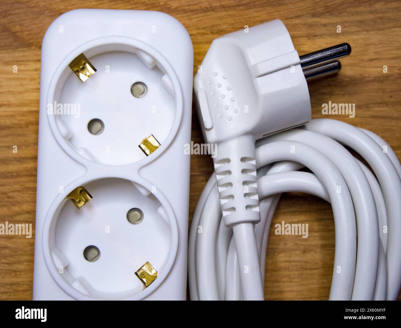 Electrical plug and socket on wood, showcasing a concept of power ...
