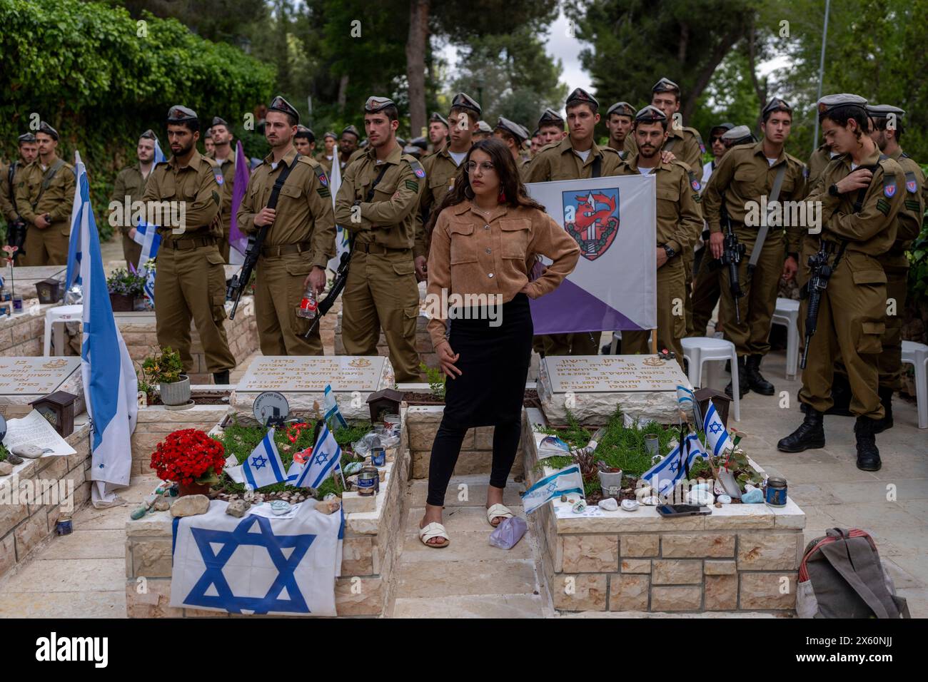 Israeli soldiers and family members of fallen soldiers visit their ...