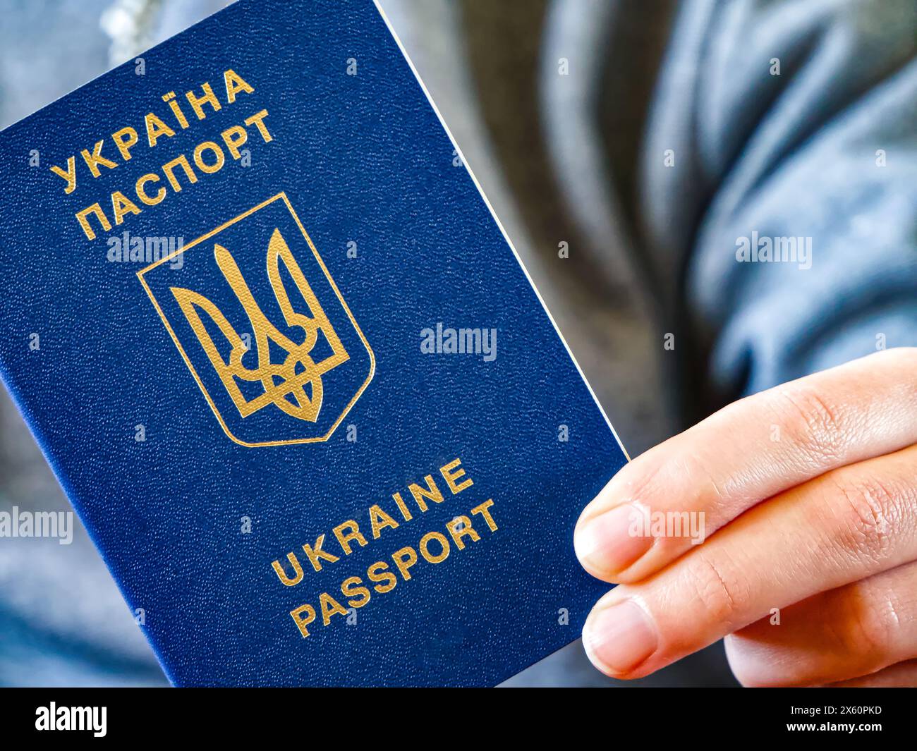 Ukrainian passport in hand, symbolizing readiness for travel and ...