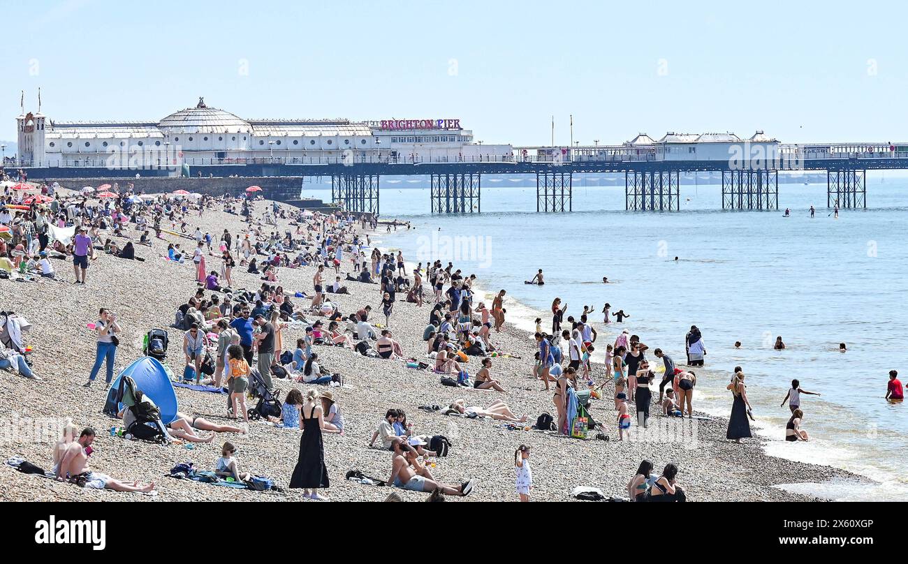 Brighton UK 12th May 2024 - Visitors enjoy the hot sunny weather on ...