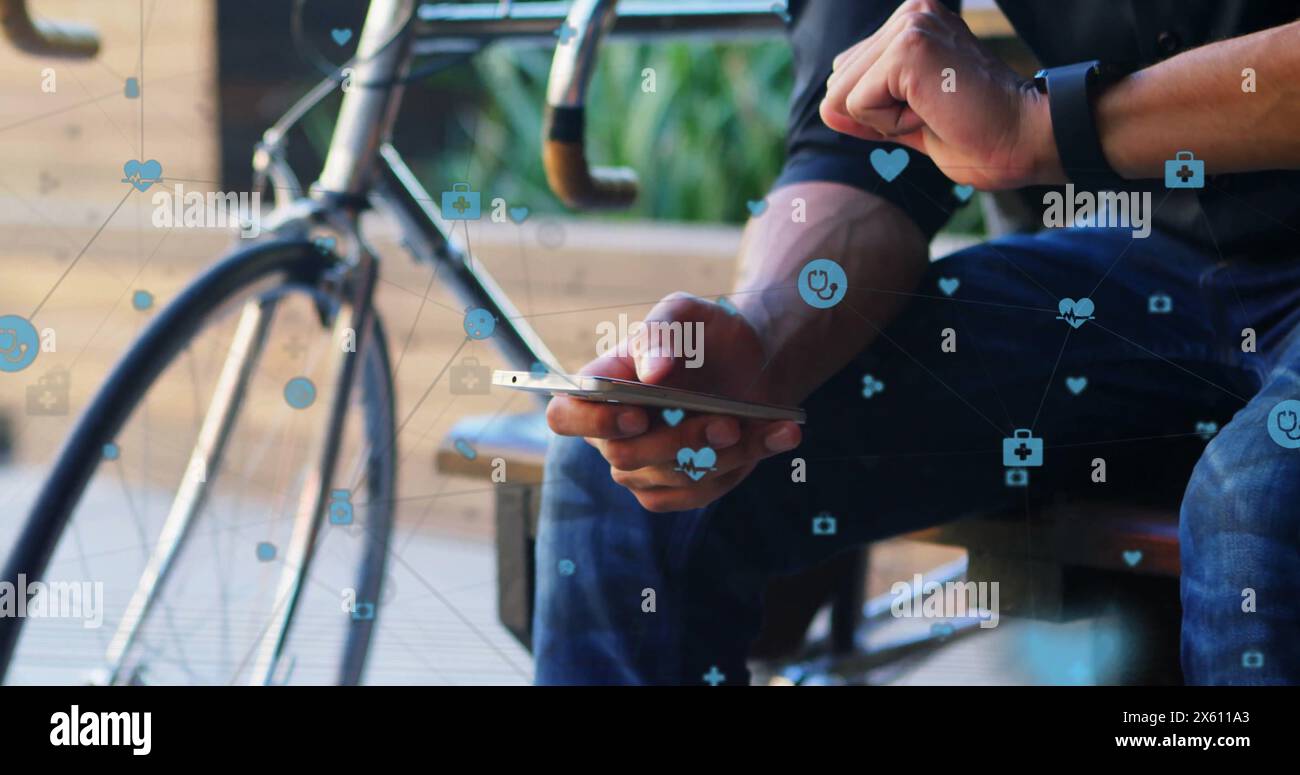 Image of connected icons, biracial man looking at smartwatch and scrolling on cellphone Stock ...