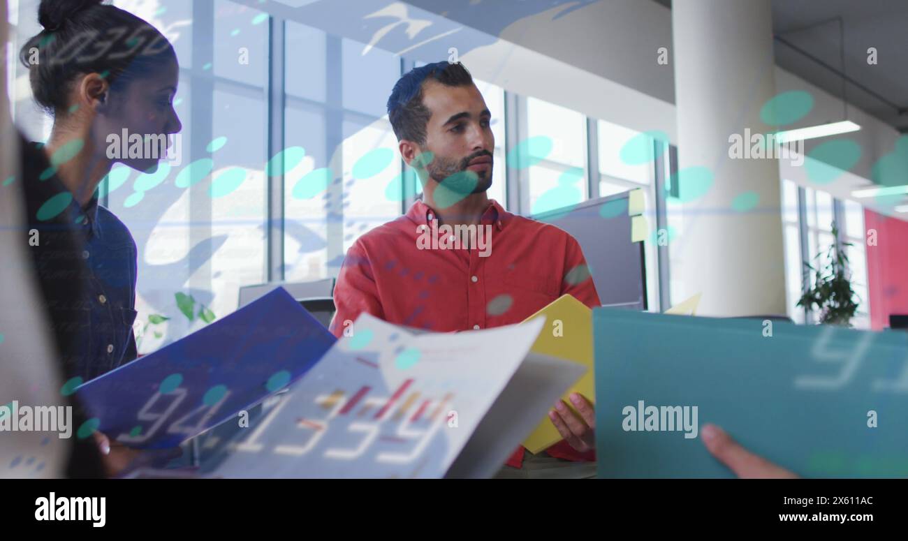 Image of graph, changing numbers, map over diverse coworkers sharing ...