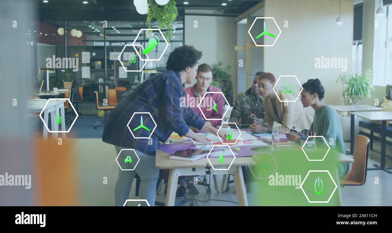 Image of icon in hexagons over diverse coworkers sharing ideas in ...