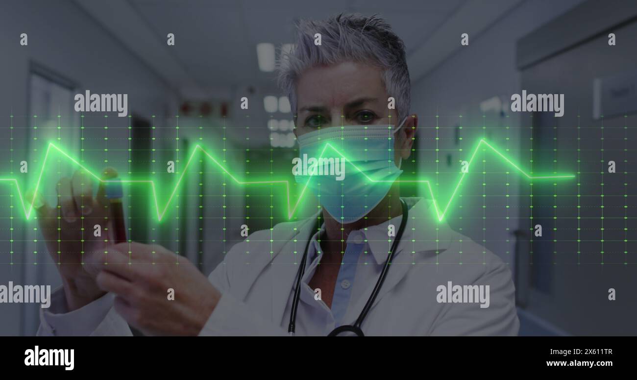 Image of heart rate monitor against caucasian female doctor holding a ...