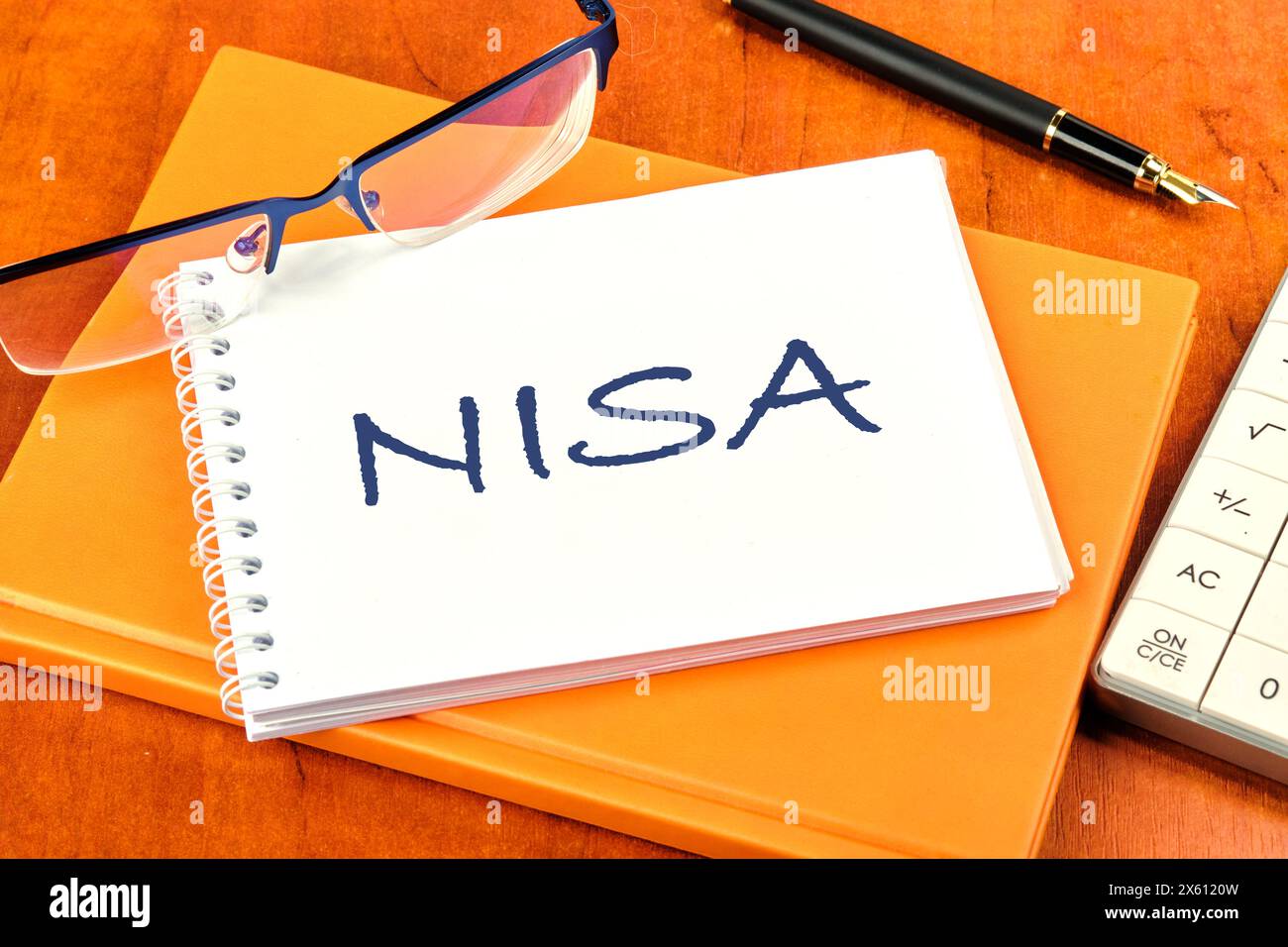The word Nippon Individual Savings Account. NISA inscription on the notebook lying on the ...