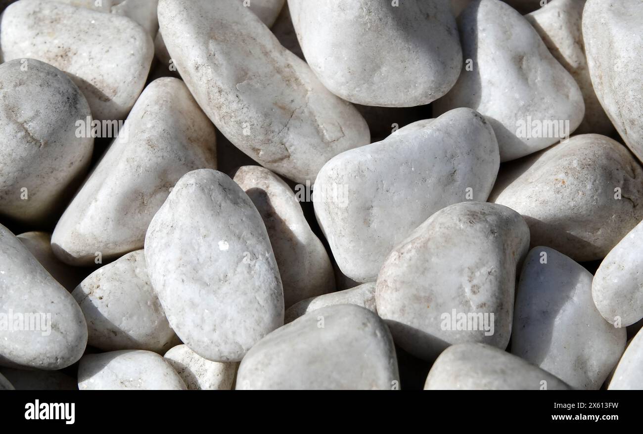 Background - white tumbled marble stones on the coast of a unique sea ...