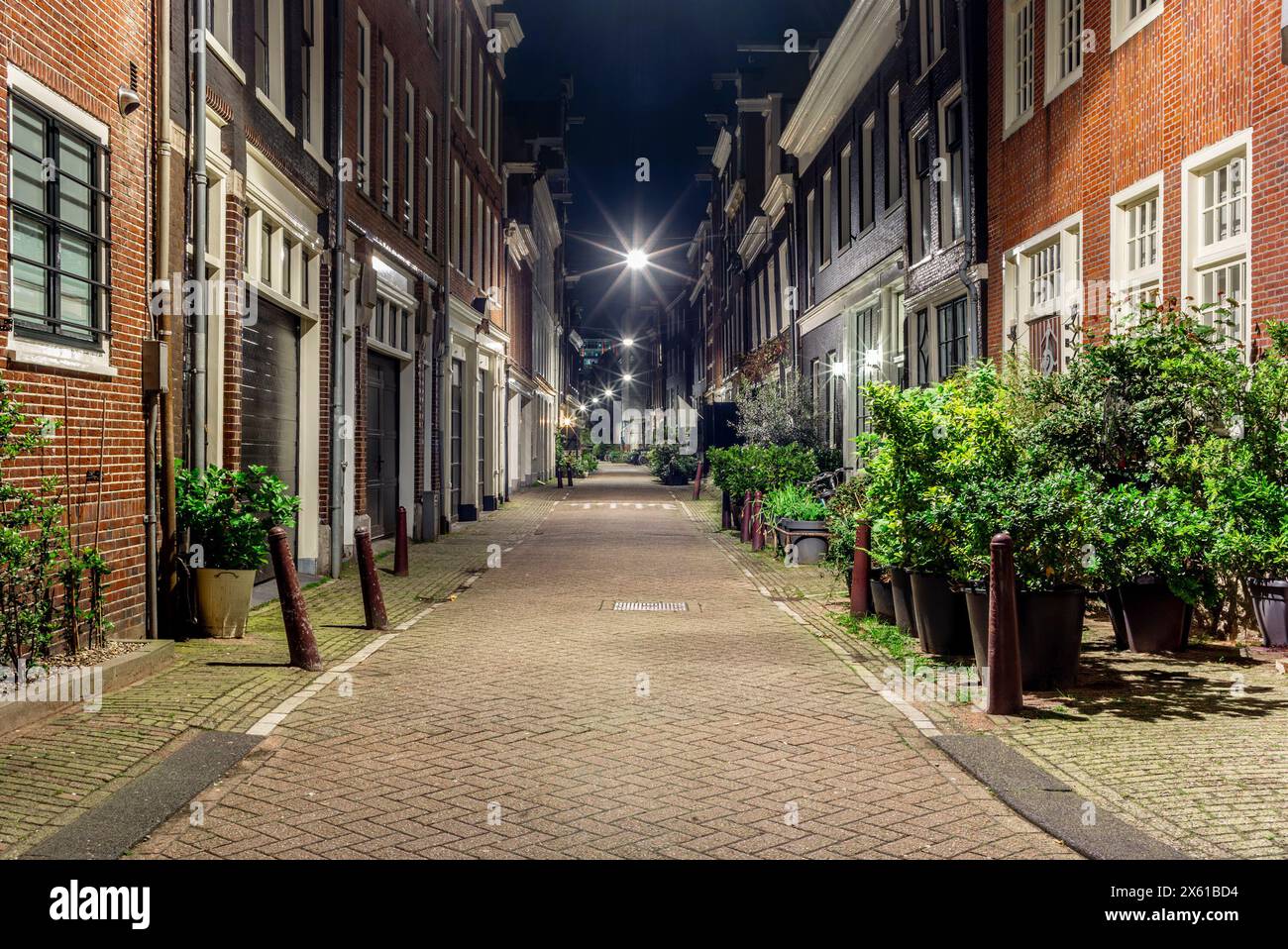 A typical cobbled stone lane in Amsterdam late at night with ...
