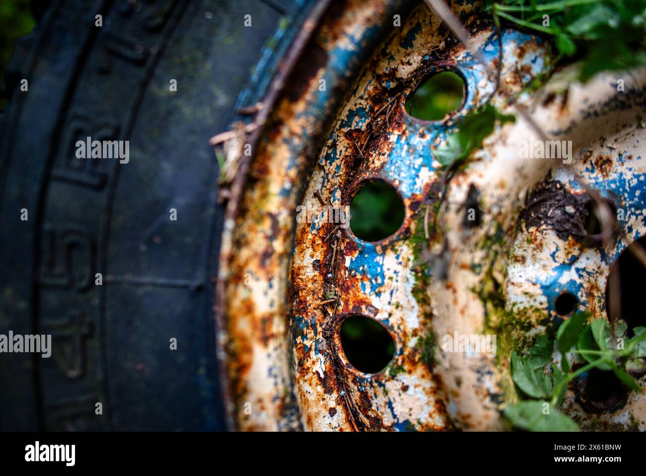 close-up of an old car wheel with a ruined black tire and rusty rim ...