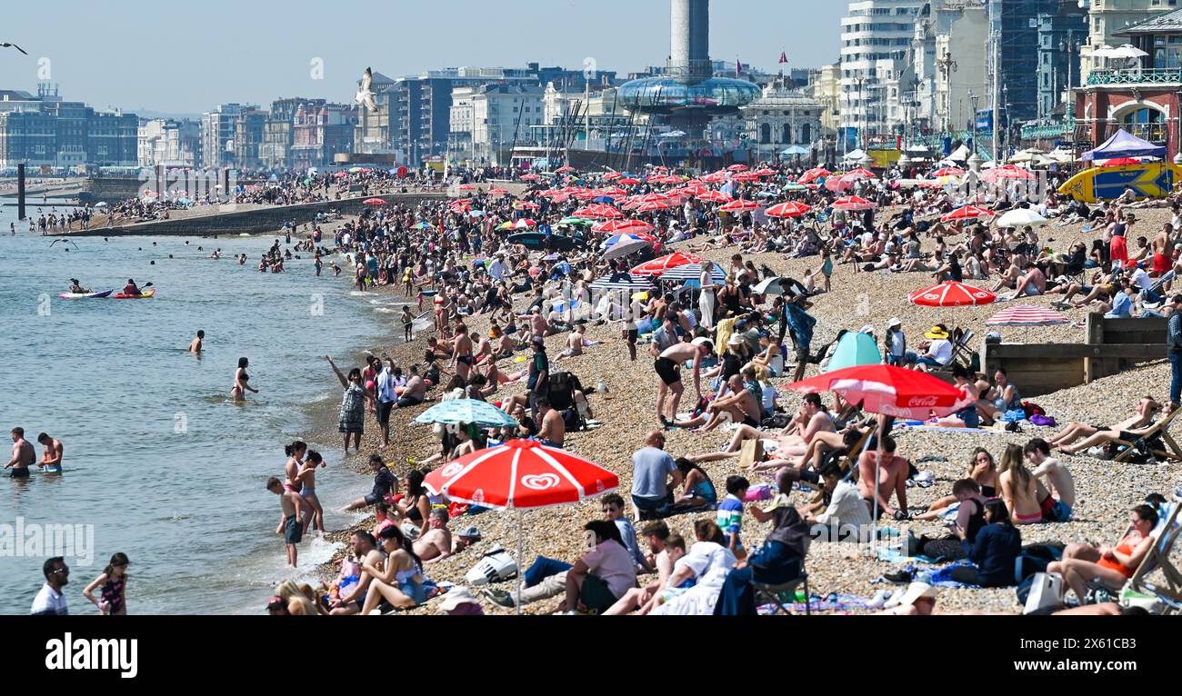 Brighton UK 12th May 2024 - Visitors enjoy the hot sunny weather on a ...