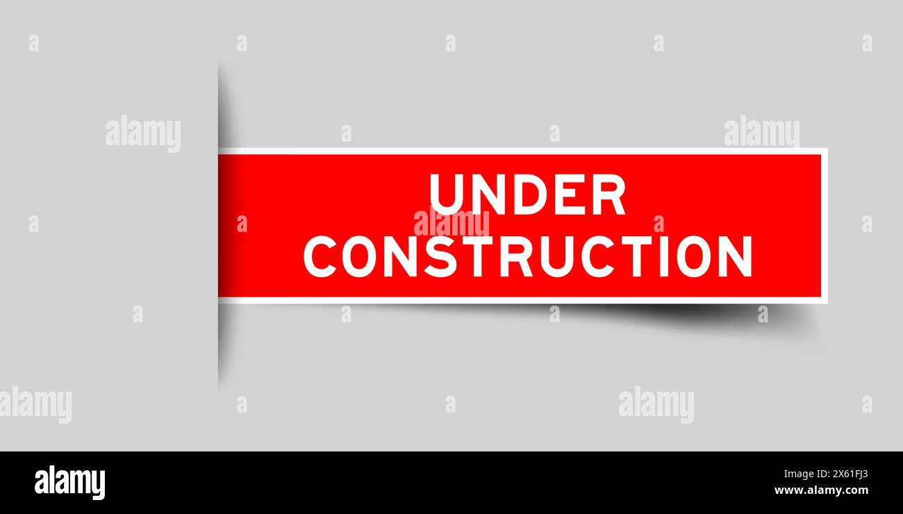 Red color square label sticker with word under construction that ...