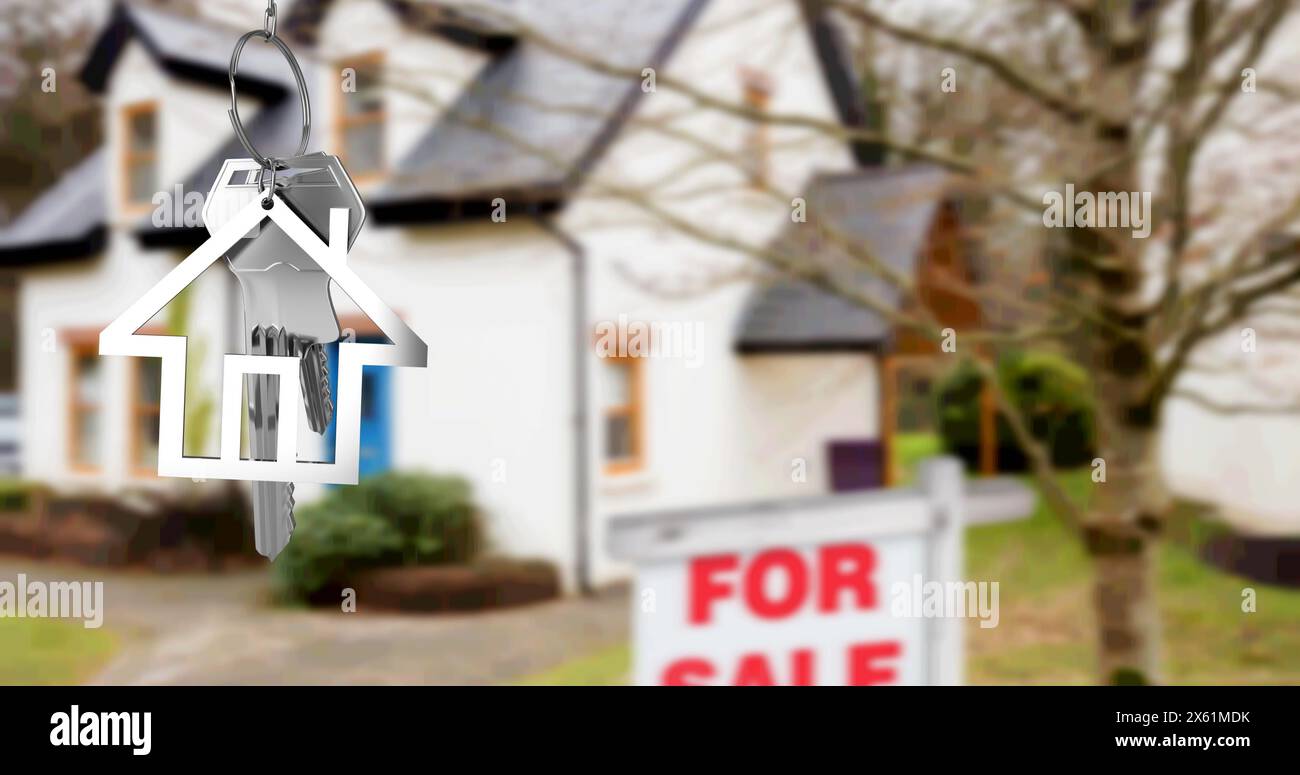 Image of silver house key fob and key, hanging in front of blurred ...