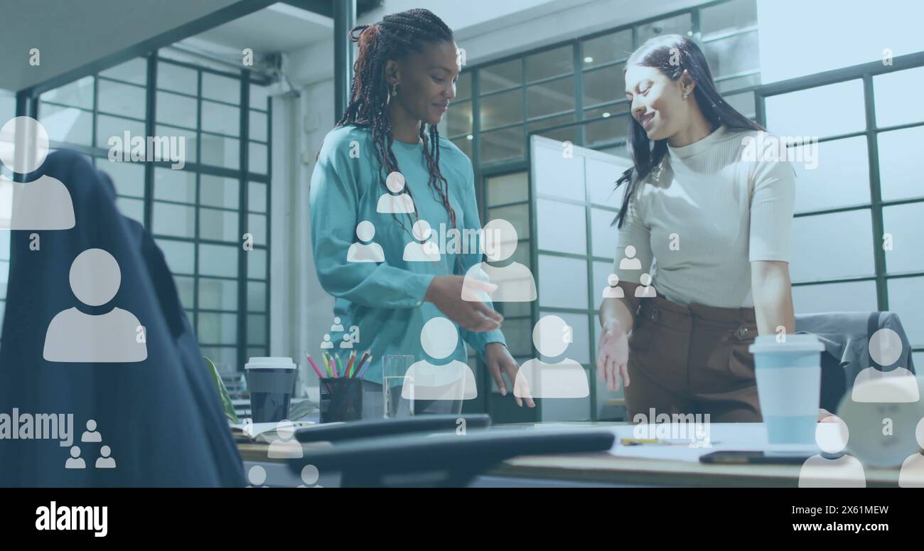 Image of flowcharts over diverse female coworkers sharing ideas on ...