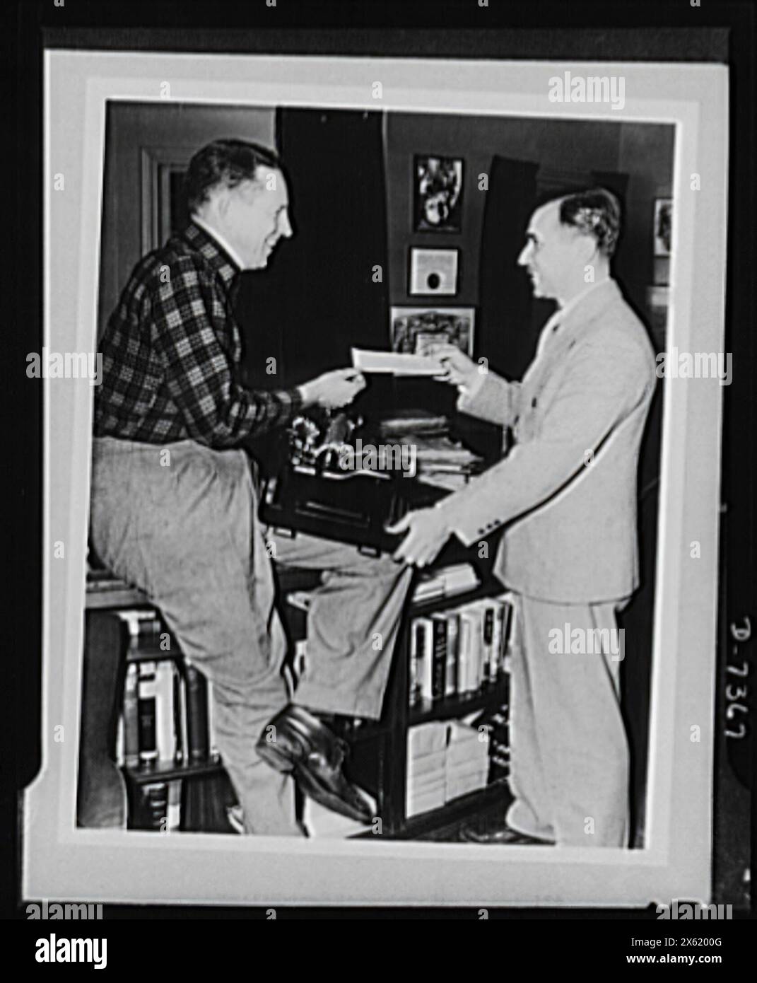 Pultzer Prize winning author Louis Bromfield [left] hands one of his ...