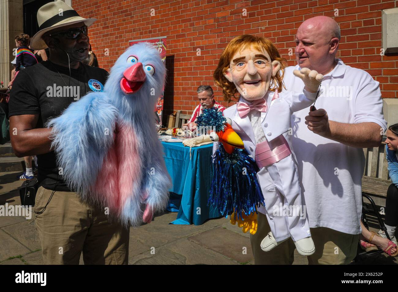 London, UK. 12th May, 2024. Two hand puppets chat to visitors. The ...