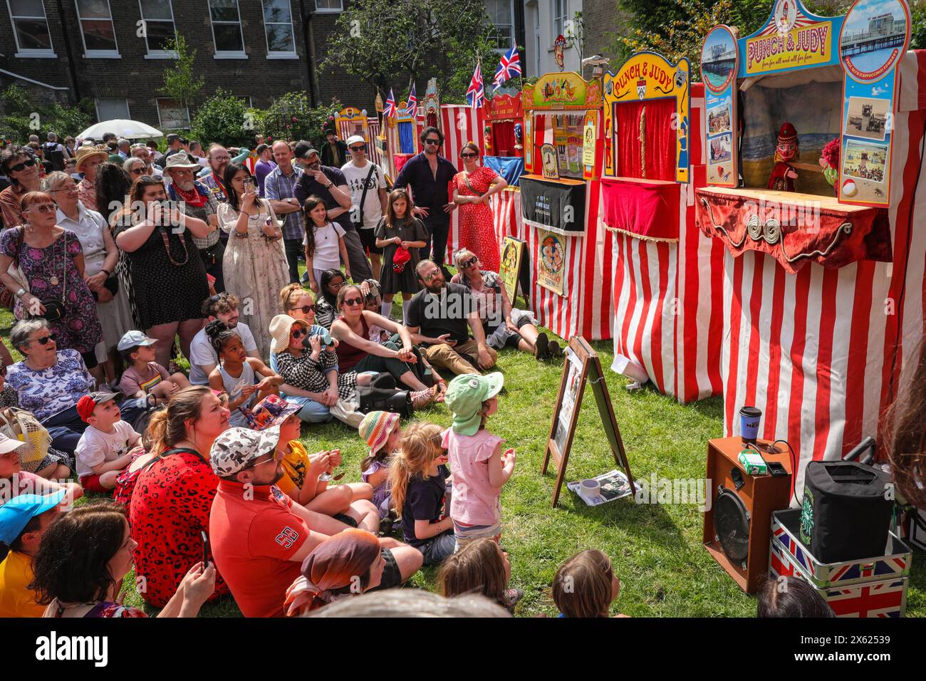 London, UK, 12th May 2024. Kids and adults watch a show by one of the ...