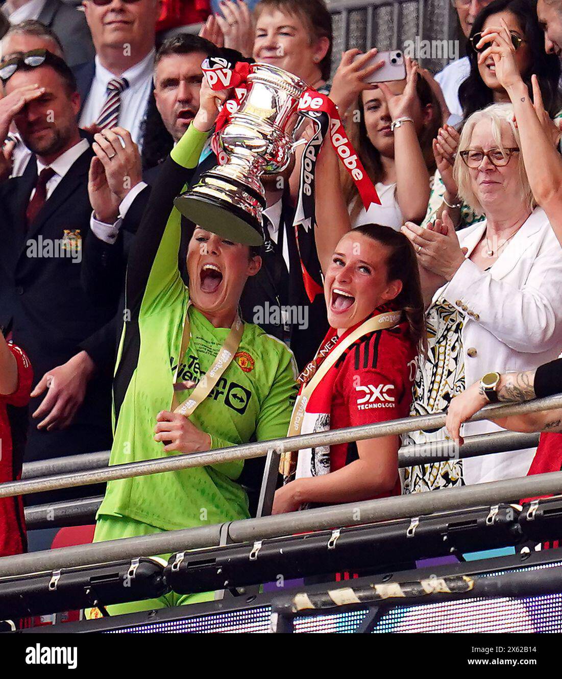 Manchester United goalkeeper Mary Earps and Ella Toone lift the trophy ...