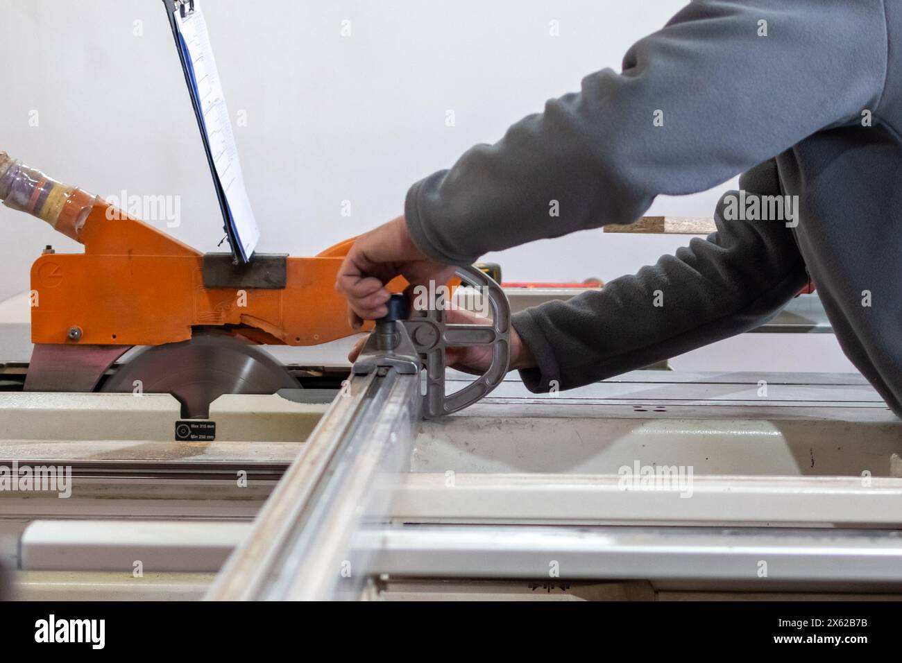 Furniture manufacture. Cutting wood panels on circular saw in ...