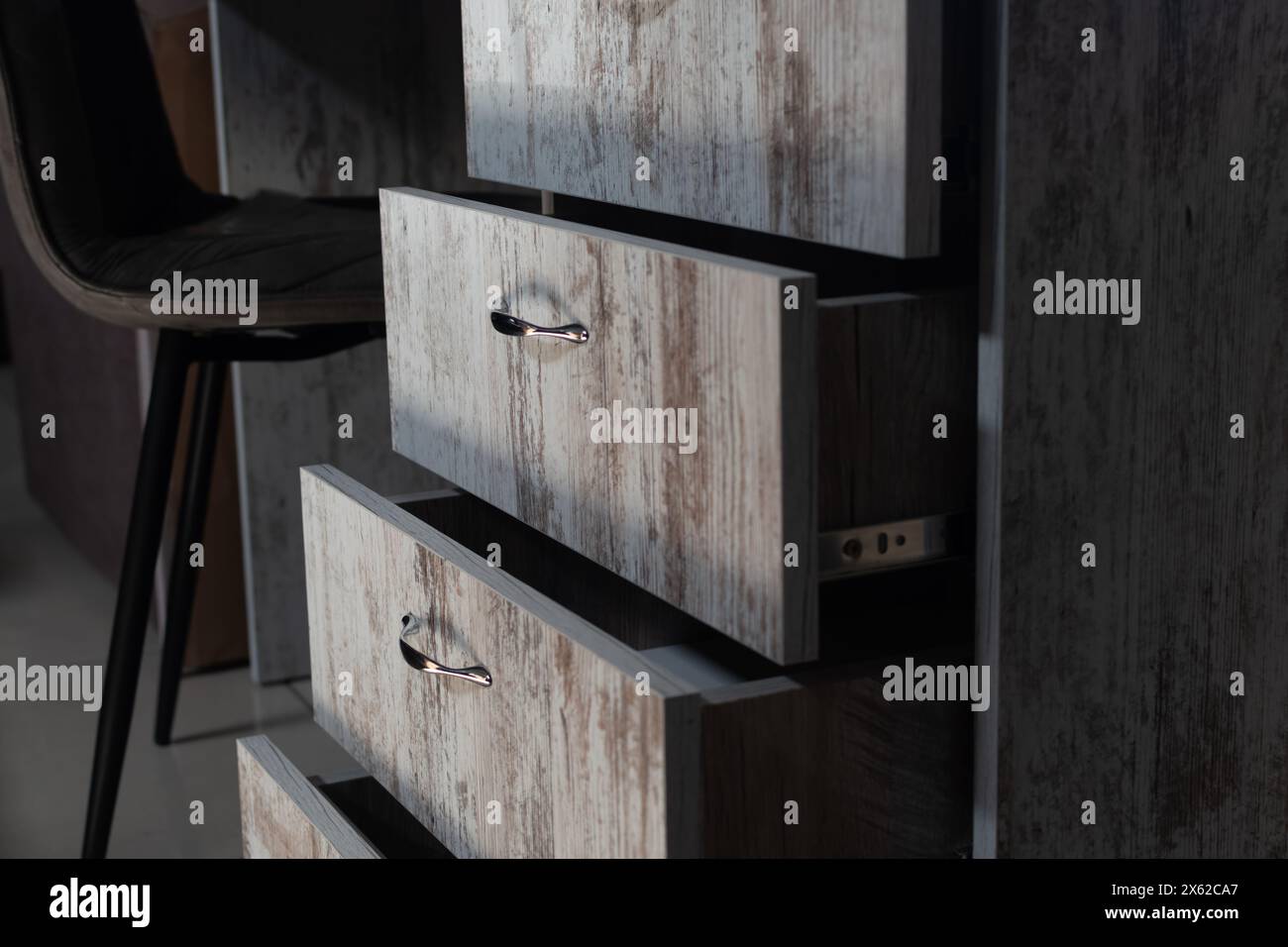 Cabinet furniture. Opened extended drawers of office desk close-up made ...