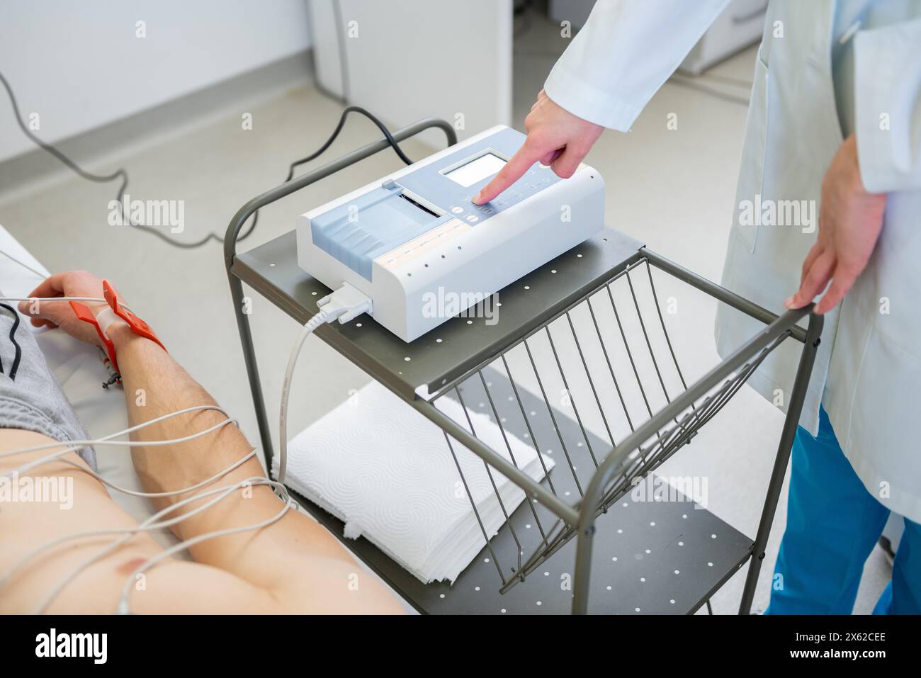Healthcare professional administers an ECG test to monitor a patients ...