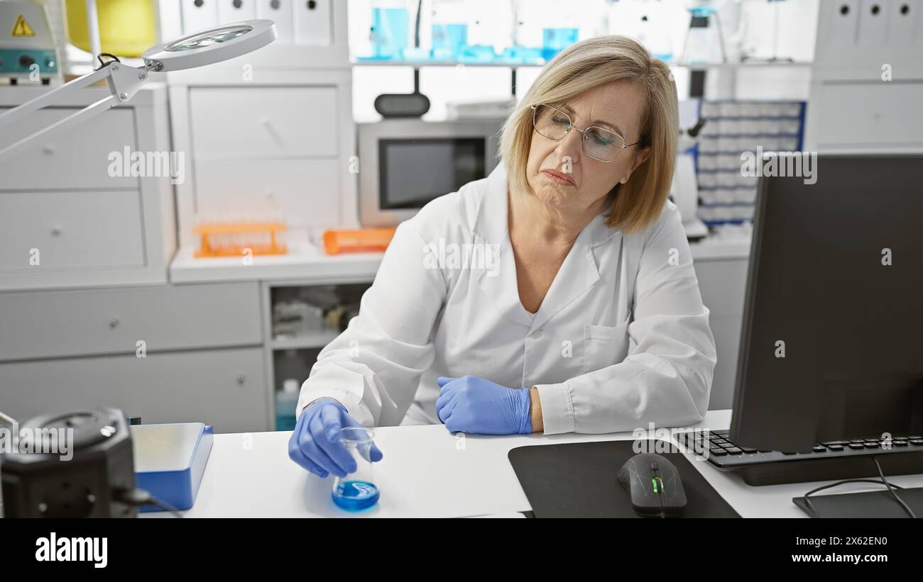 A focused middle-aged woman scientist analyzing a sample in a ...